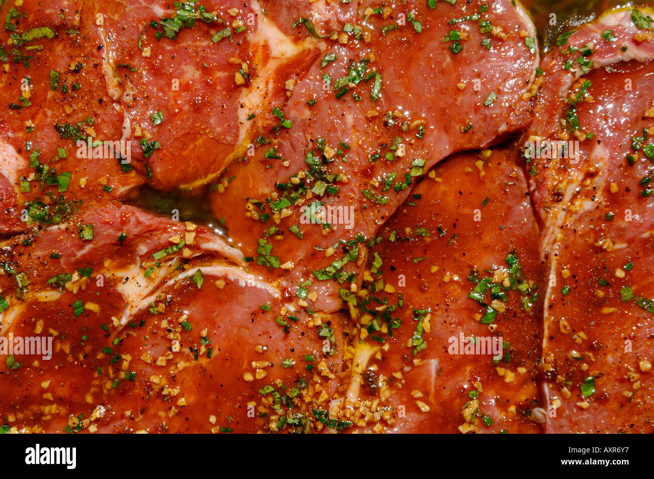 Marinating rib eye steaks Stock Photo - Alamy