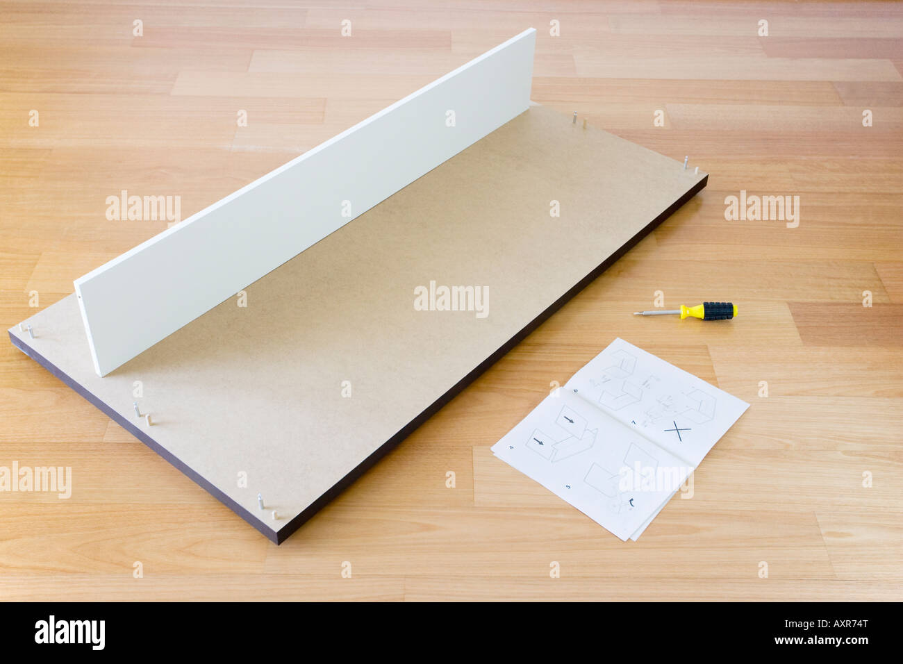 The underside of a self-assembly desk with instructions and a ...