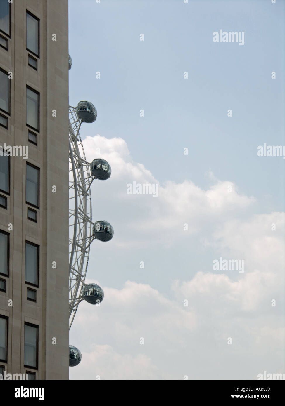 the edge of the london eye appears behind the shell building on the ...