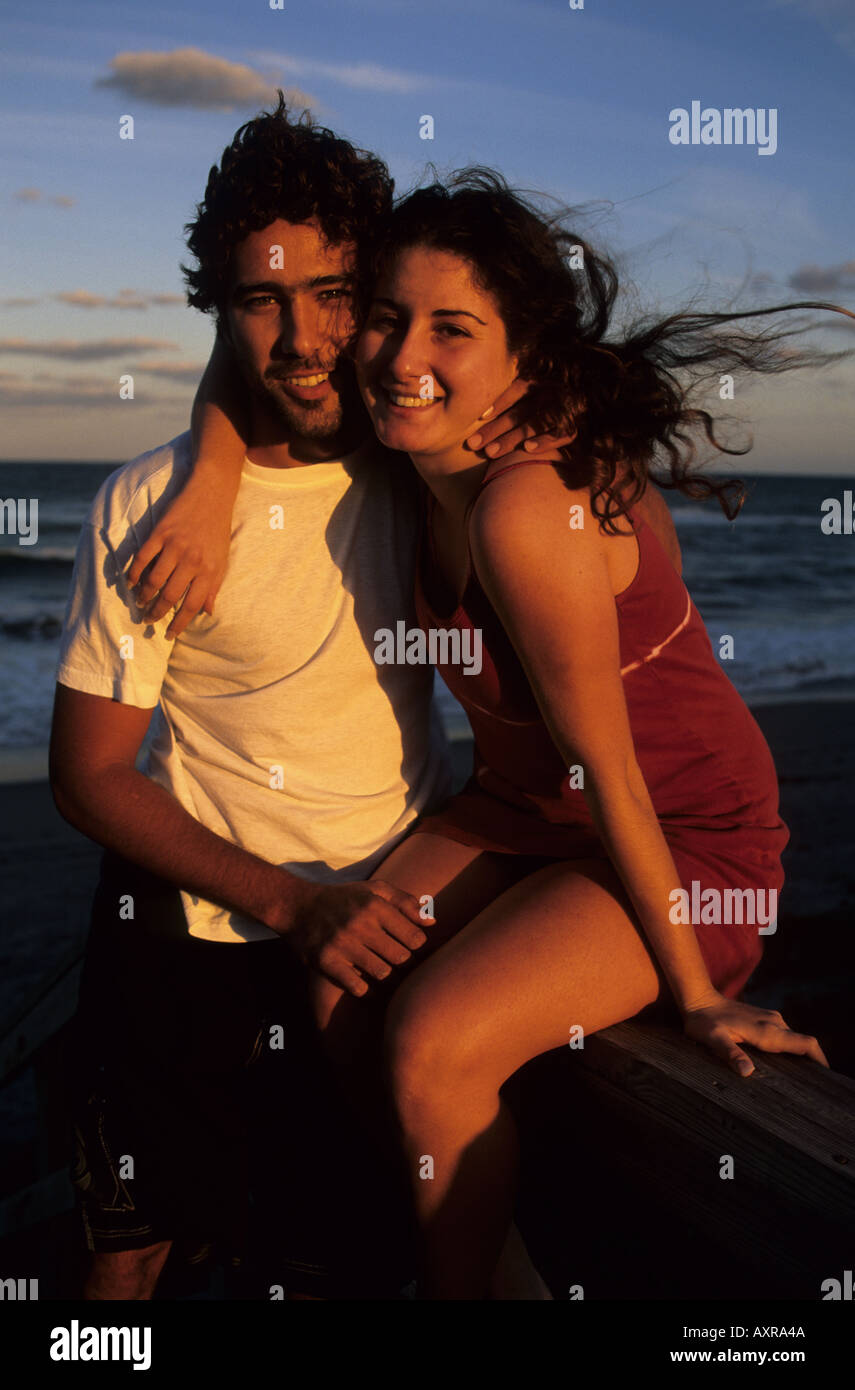 Young Italian couple 20s close together and smiling on walkway railing ...