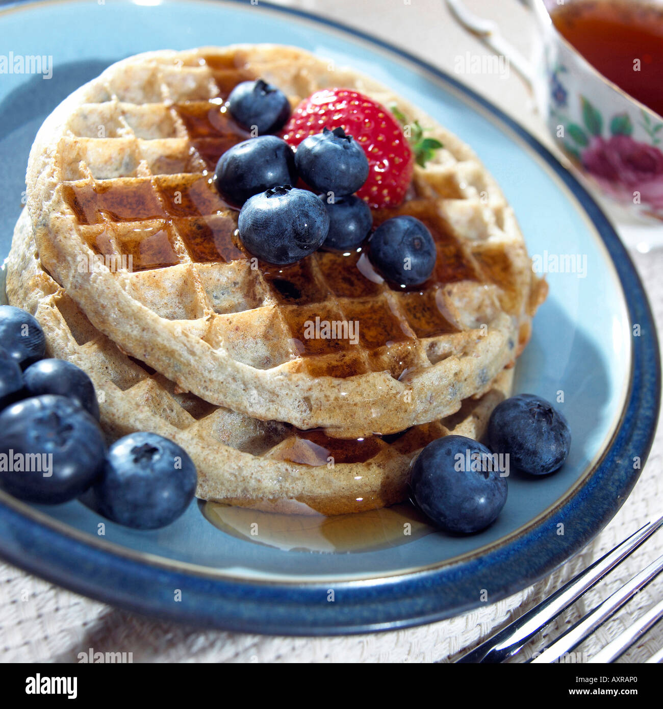 High angle view of blueberries and a strawberry on waffles Stock Photo ...