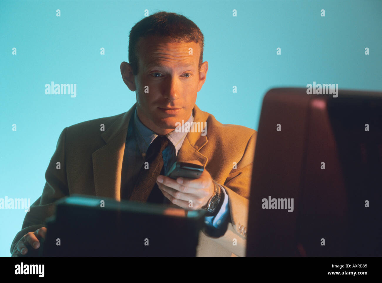 Man watching television holding remote control Stock Photo - Alamy