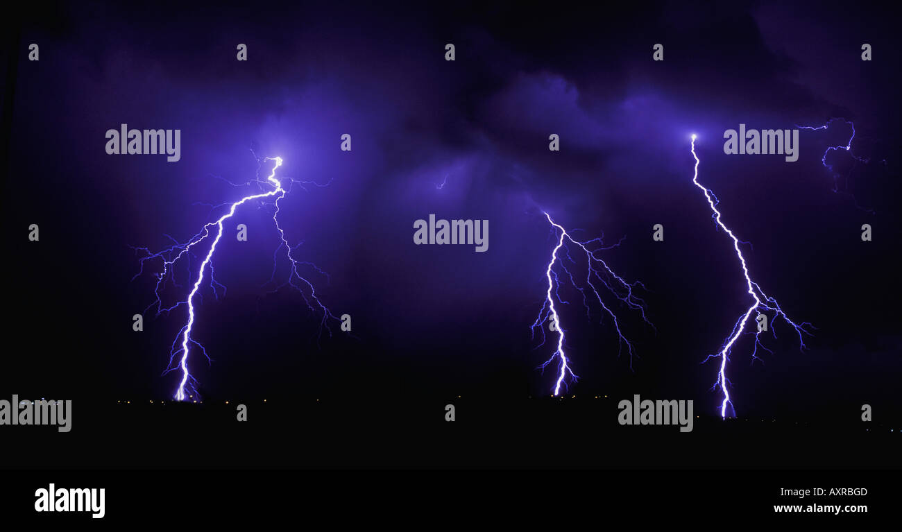 Lightning over city at night Stock Photo - Alamy