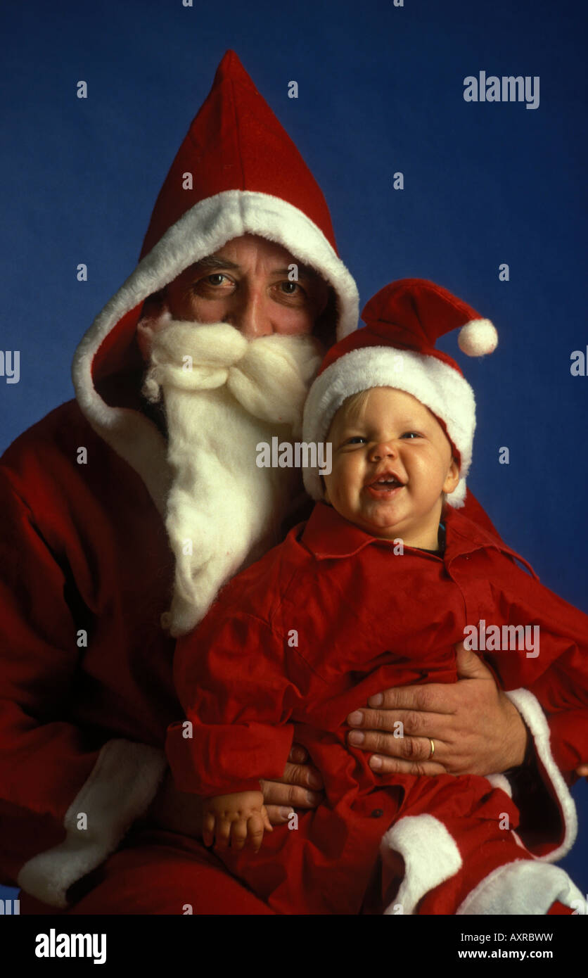 Santa Claus and his little apprentice. Father Christmas and his little ...