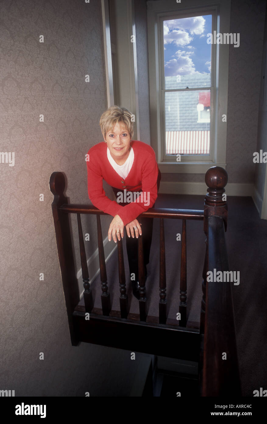 Mature Lady Leaning on Railing Stock Photo - Alamy