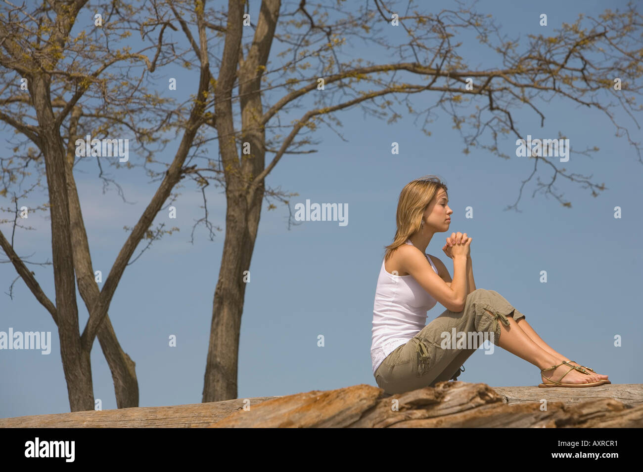 Woman praying outdoors Stock Photo - Alamy