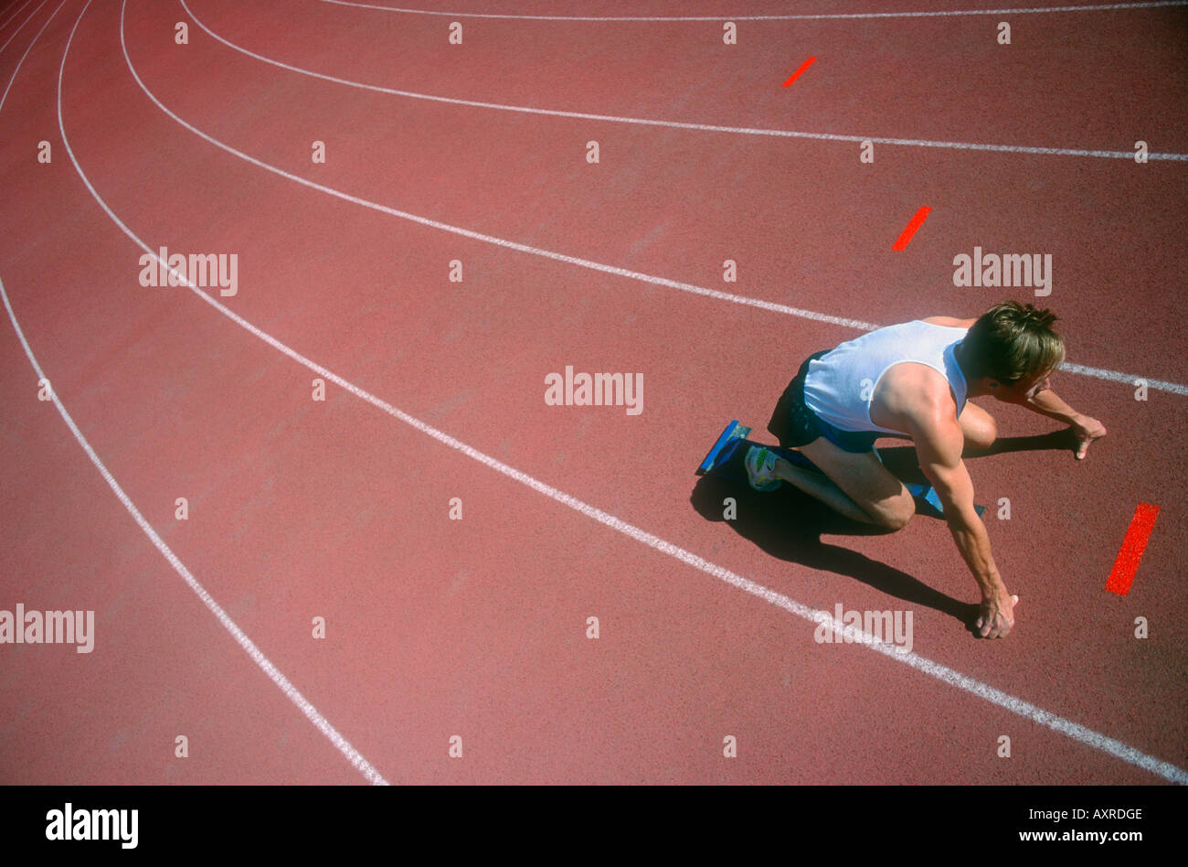 Male sprinters in starting blocks hi-res stock photography and images ...