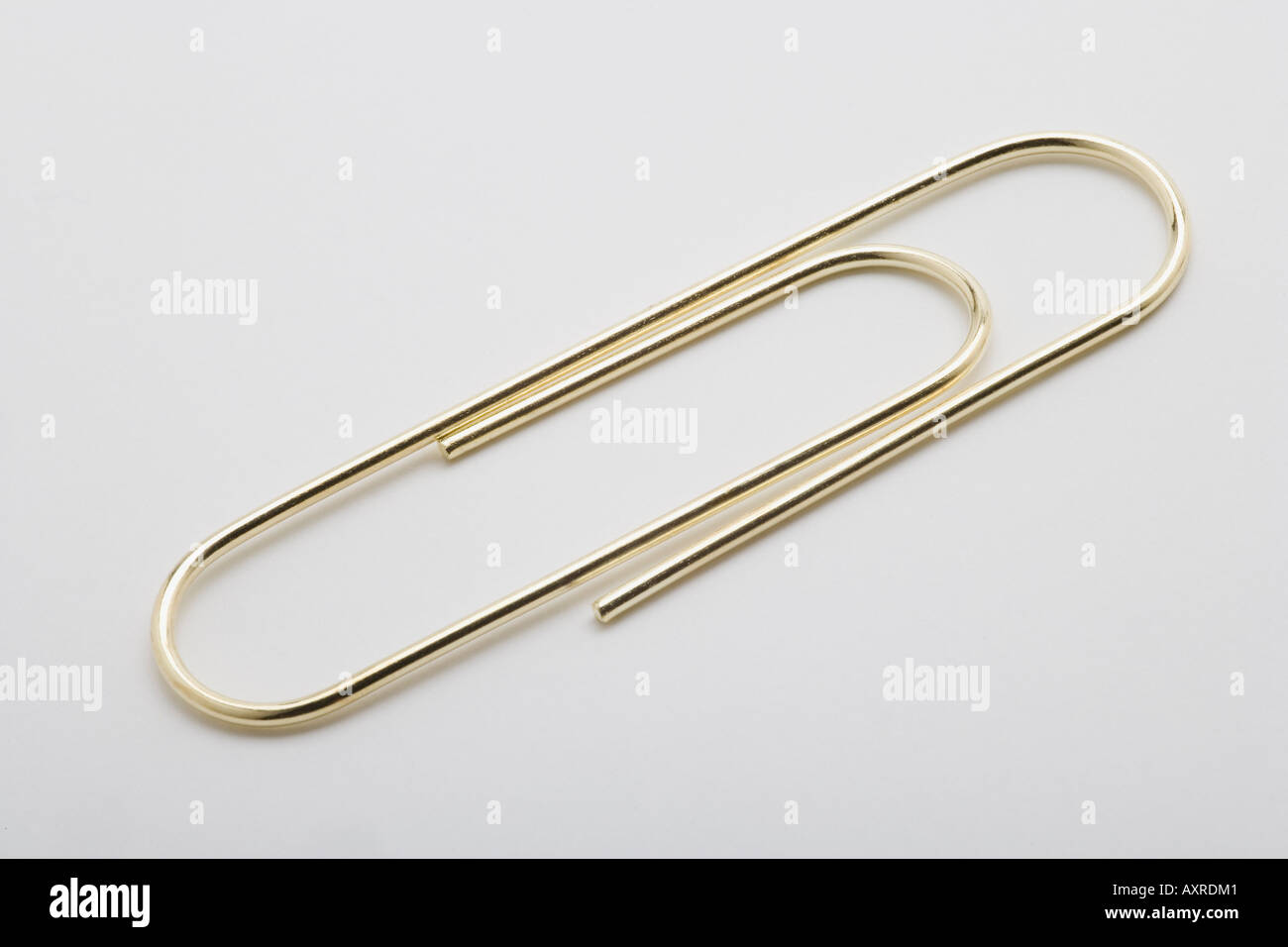 Gold paper clip Stock Photo - Alamy