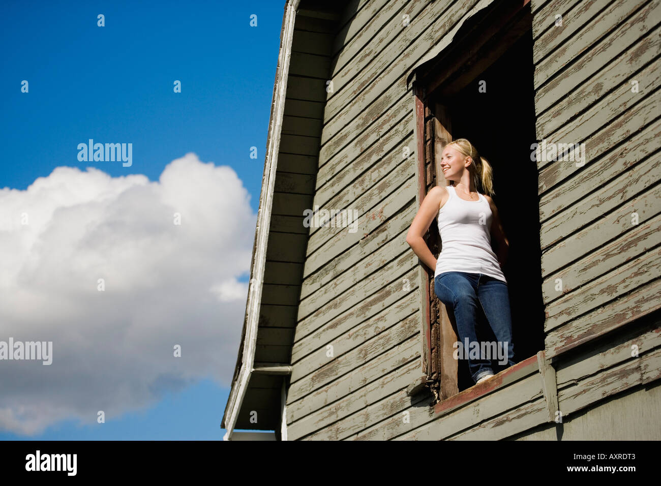 Young woman in barn loft Stock Photo - Alamy