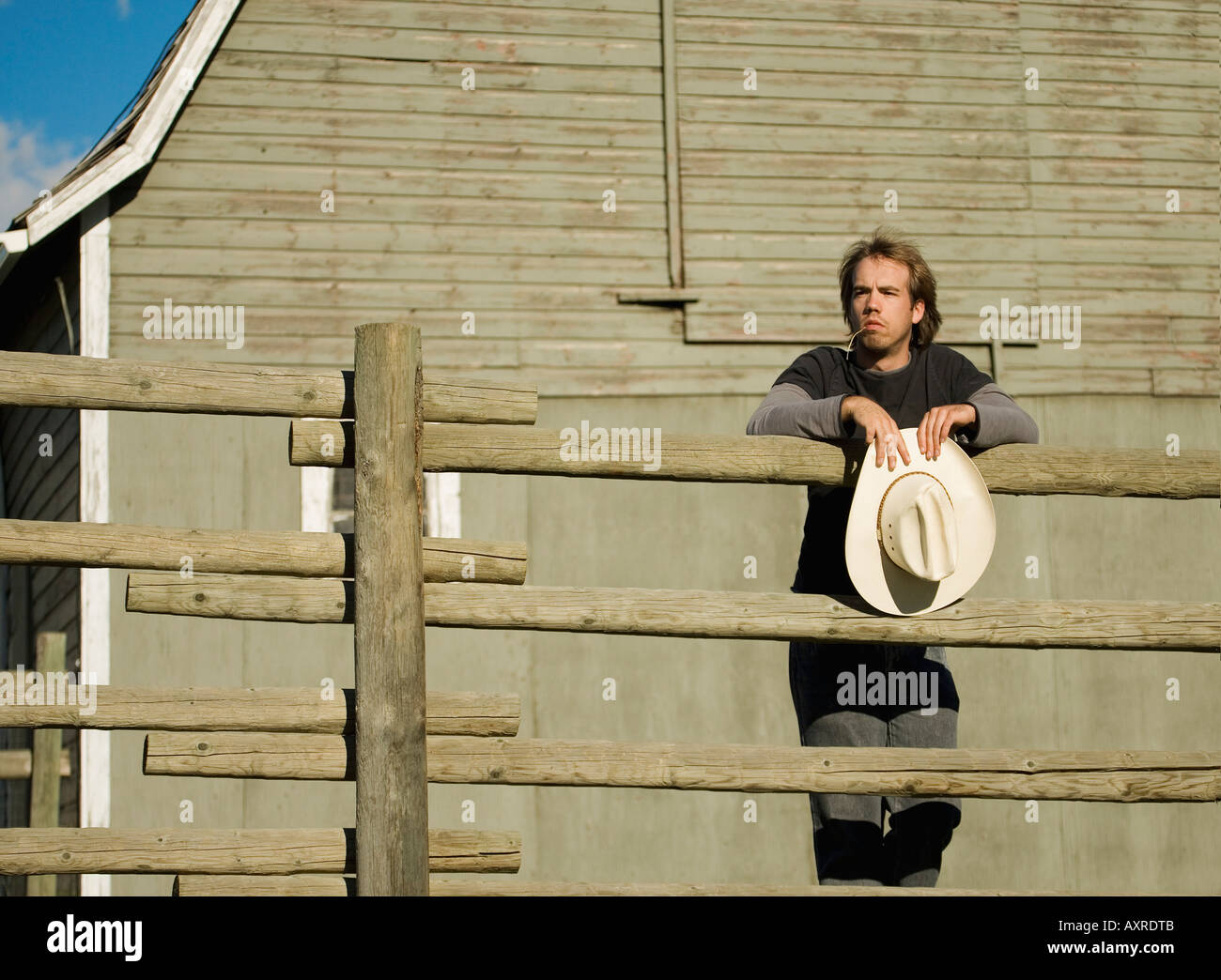 Cowboy leaning on fence hi-res stock photography and images - Alamy
