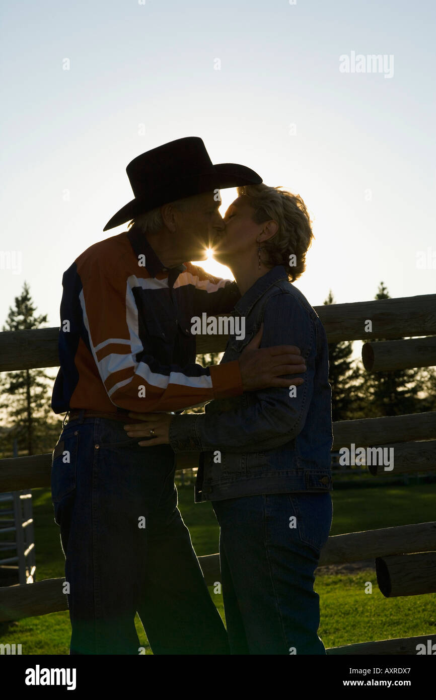 Couple kissing at ranch Stock Photo - Alamy