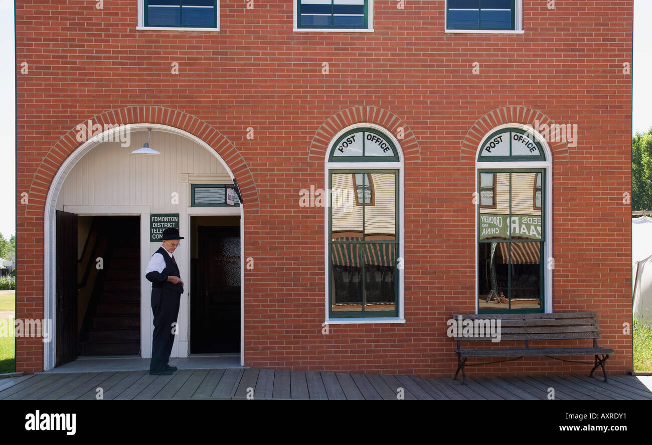 Man in front of an old fashioned post office Stock Photo - Alamy