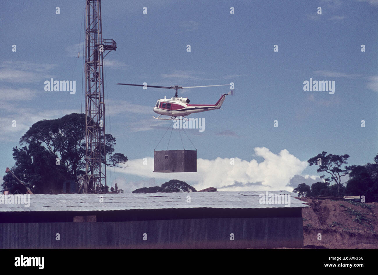 Helicopter lifting load onto oil rig Stock Photo - Alamy