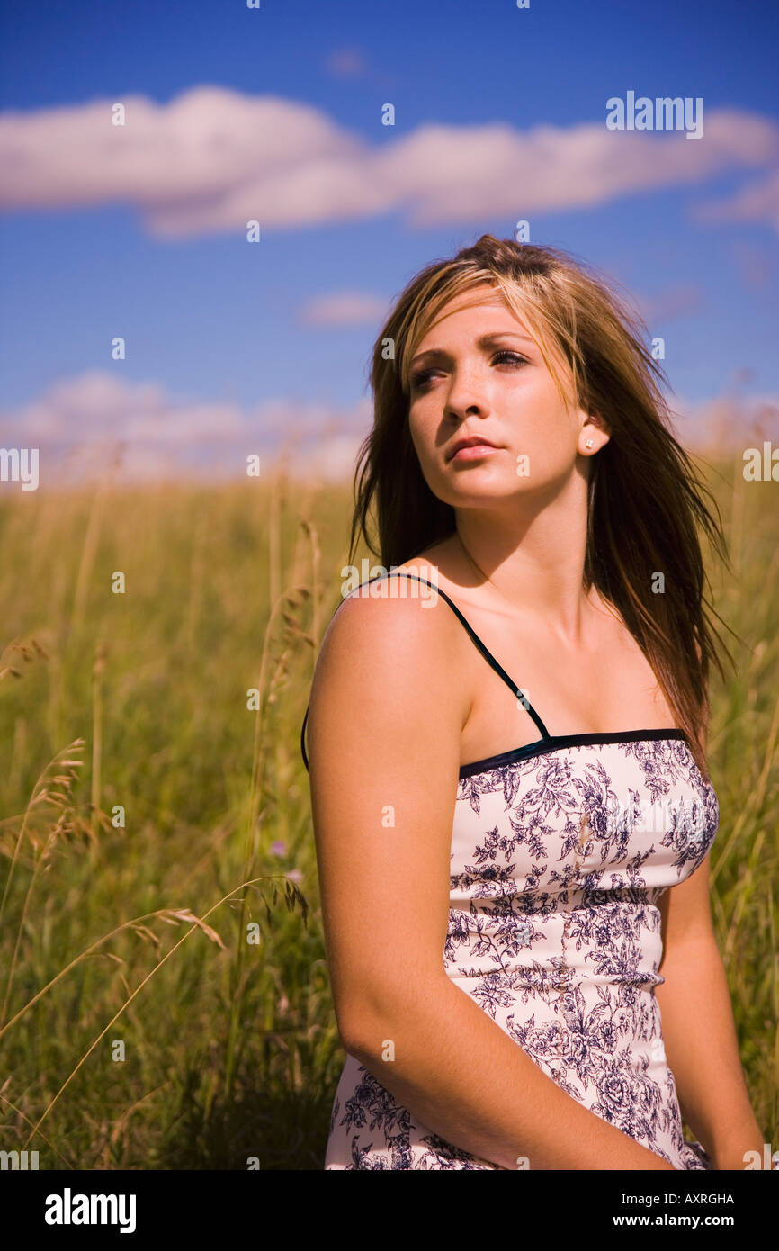 Woman sitting on field hi-res stock photography and images - Alamy