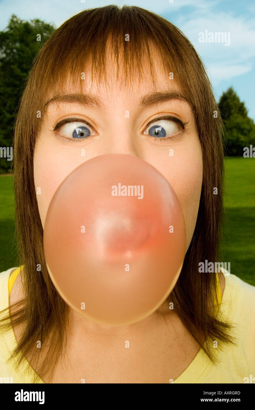 Woman blowing bubblegum Stock Photo - Alamy