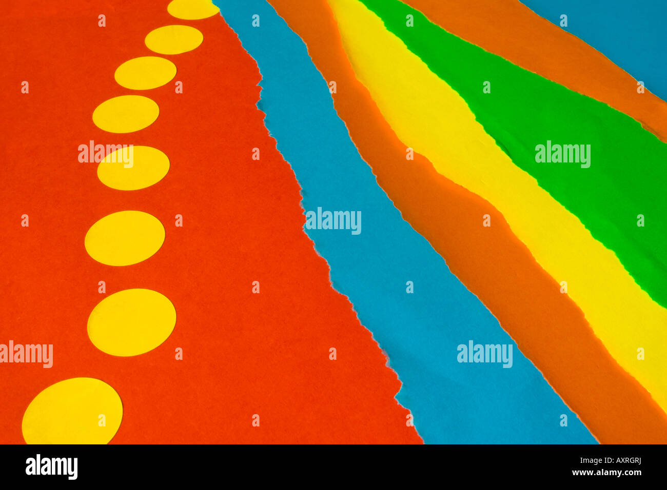 Torn coloured paper strips with yellow dots Stock Photo - Alamy