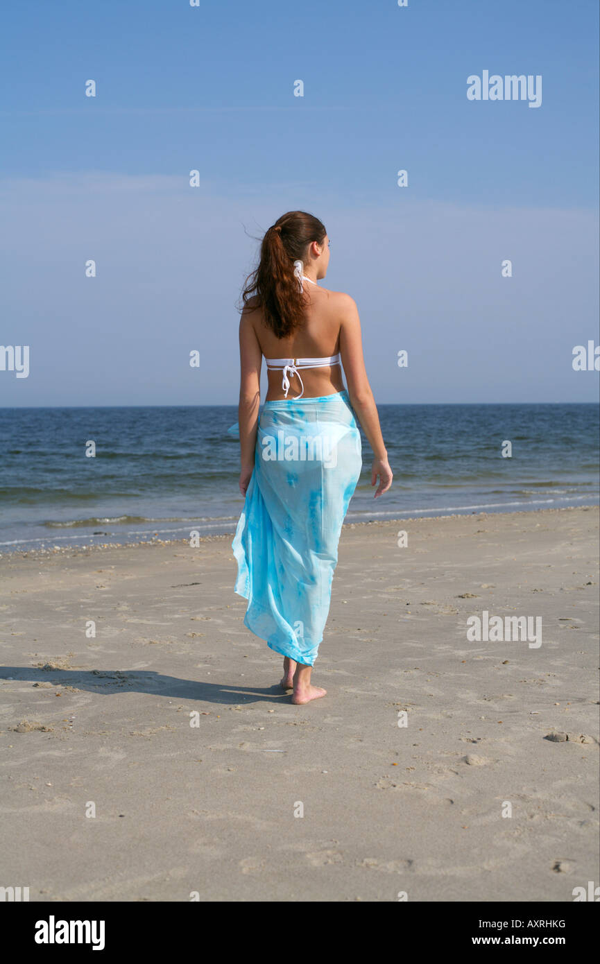 Young brunette woman promenading at the beach Stock Photo - Alamy