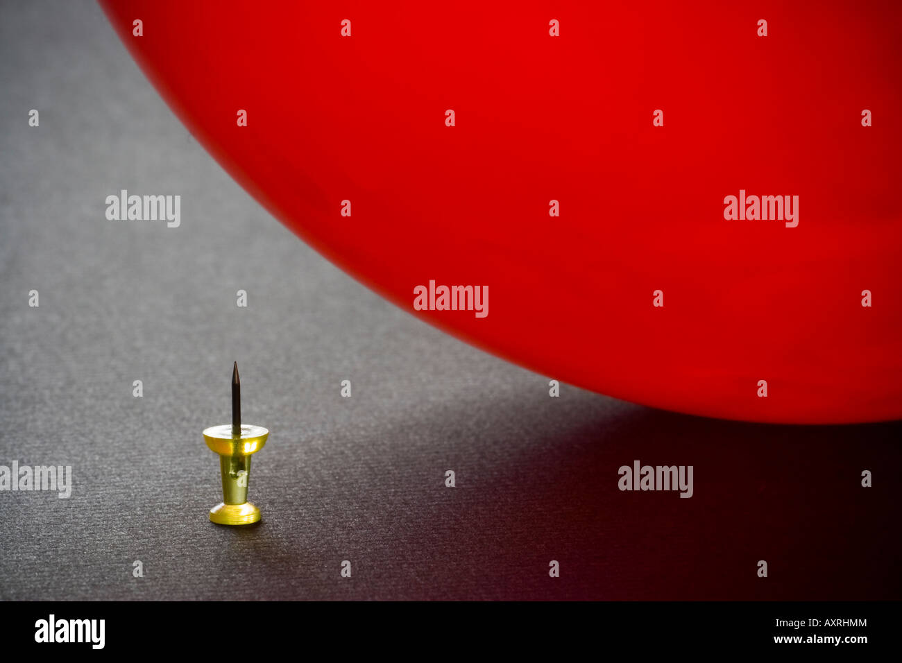 Red balloon with coloured plastic drawing pins Stock Photo - Alamy