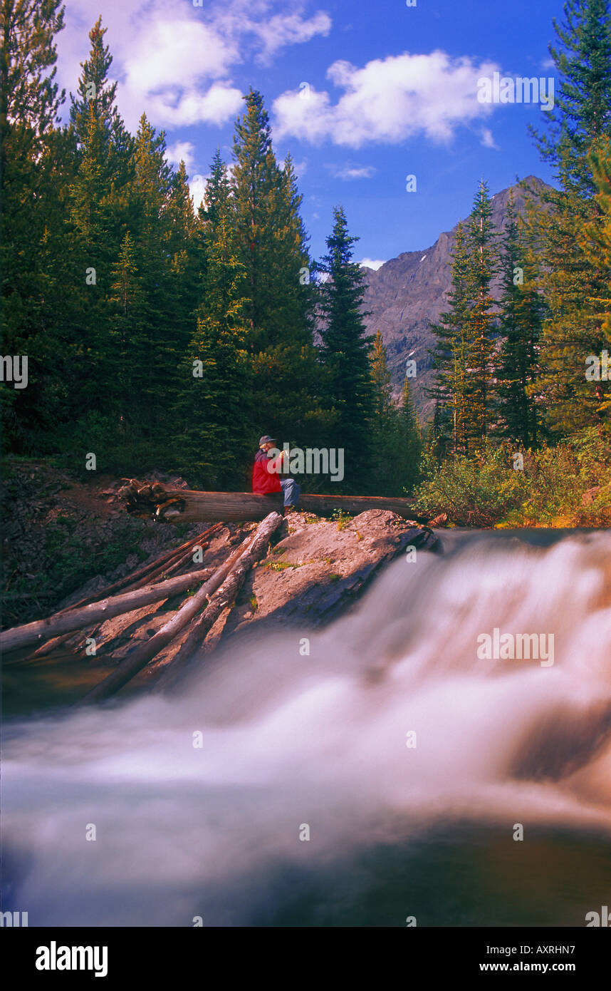Person sitting beside a waterfall hi-res stock photography and images ...