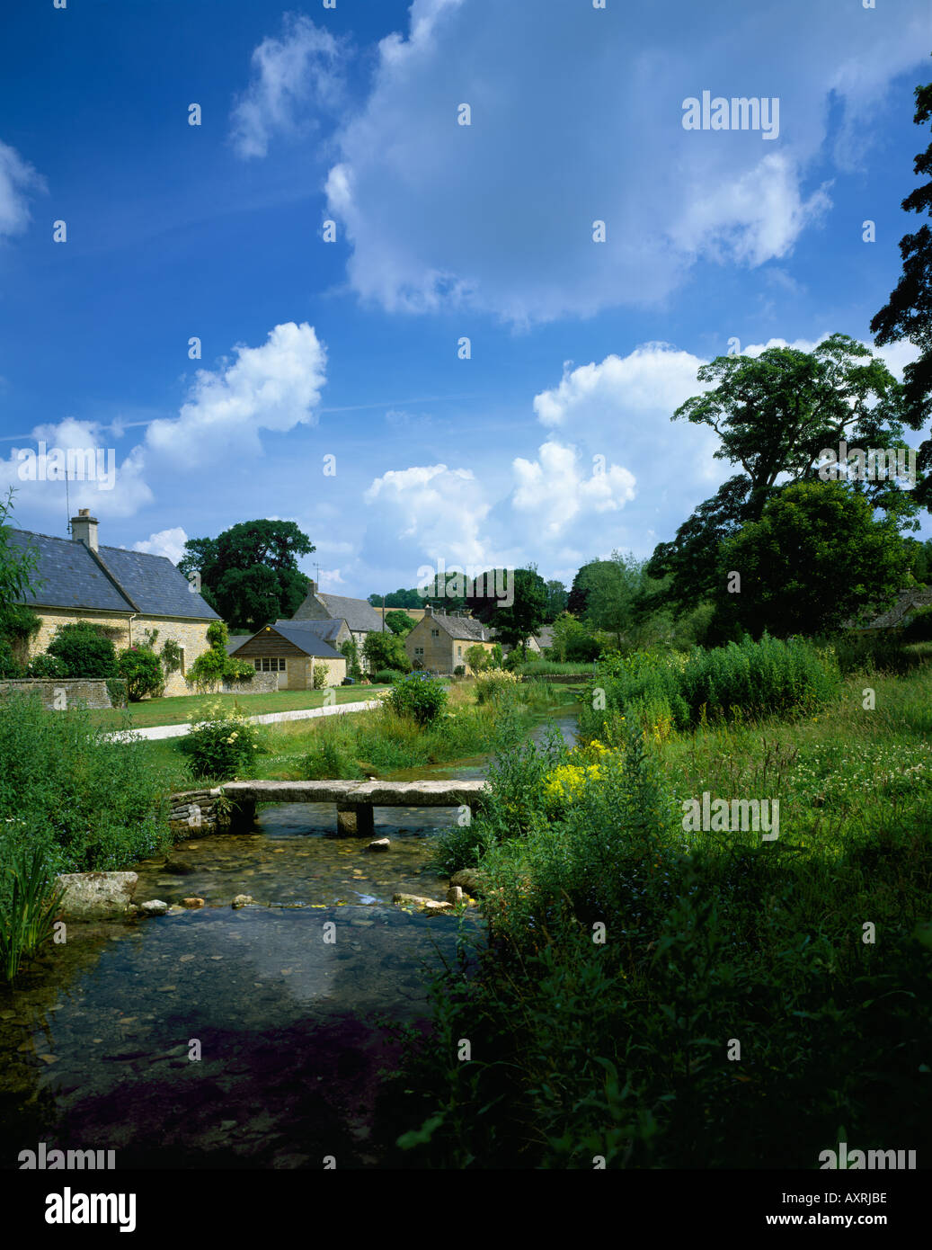 A stream flows through the picturesque cotswold village of Upper ...
