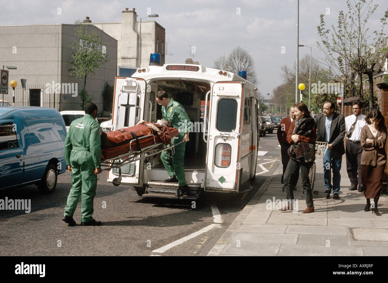 Ambulance paramedics carry patient into vehicle Stock Photo - Alamy