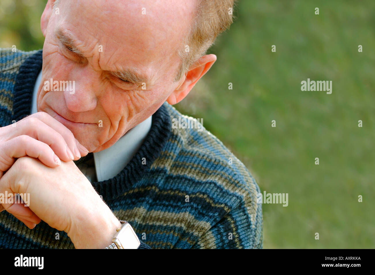 Elderly man praying Stock Photo - Alamy