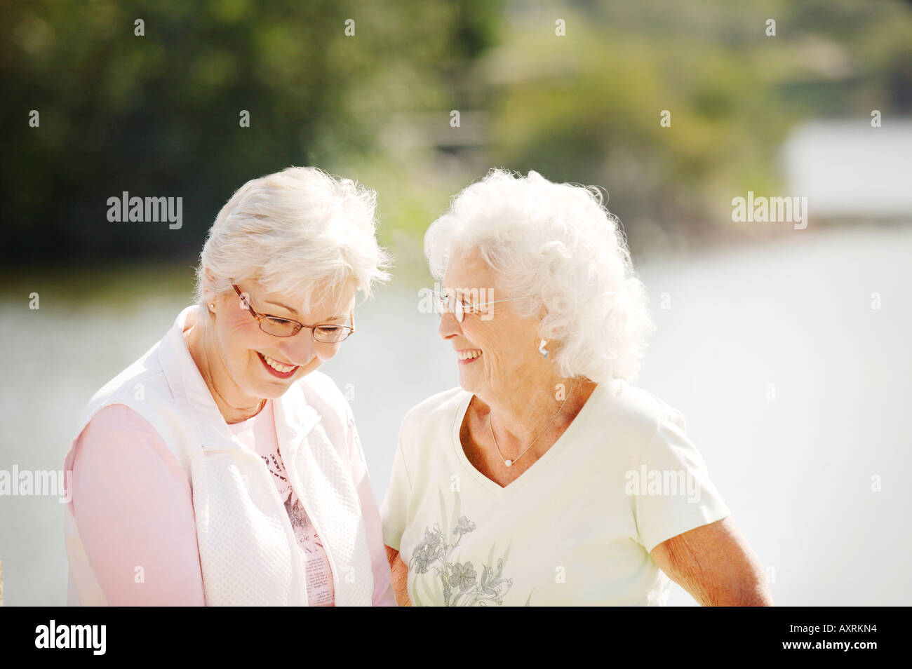 Two older women laughing Stock Photo - Alamy