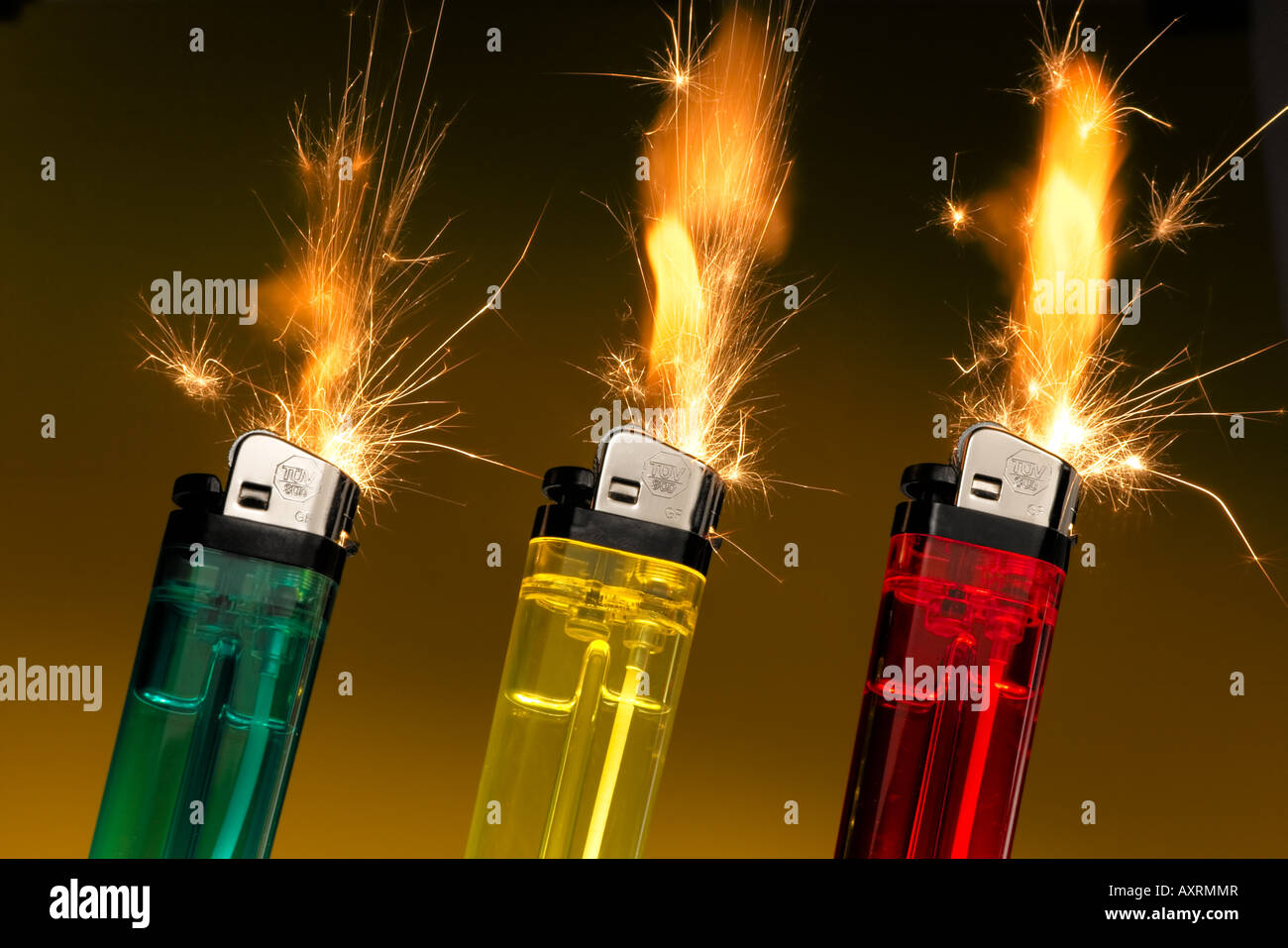 Three lighters shooting flames and sparks Stock Photo - Alamy