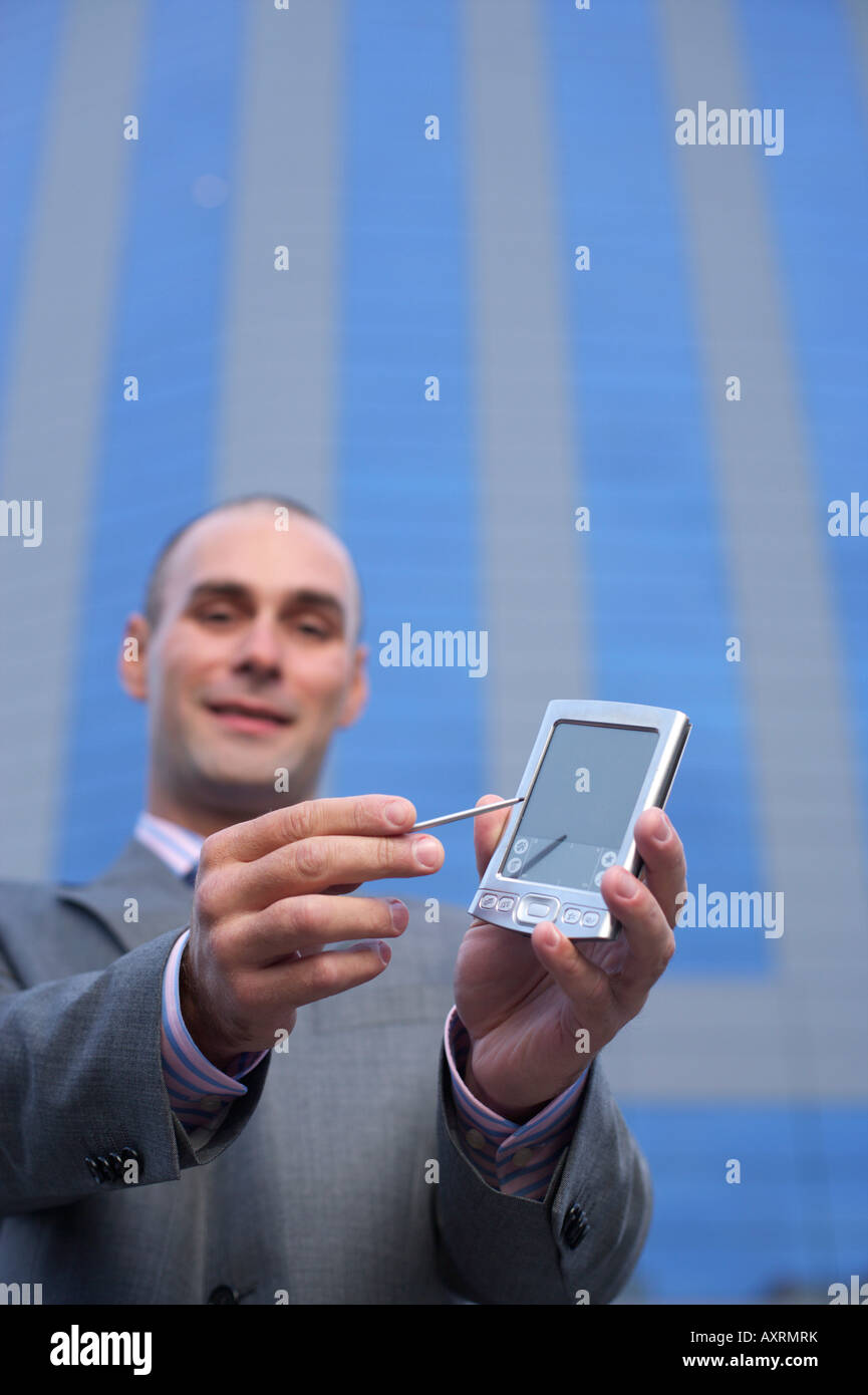 Businessman using a palmtop Stock Photo - Alamy