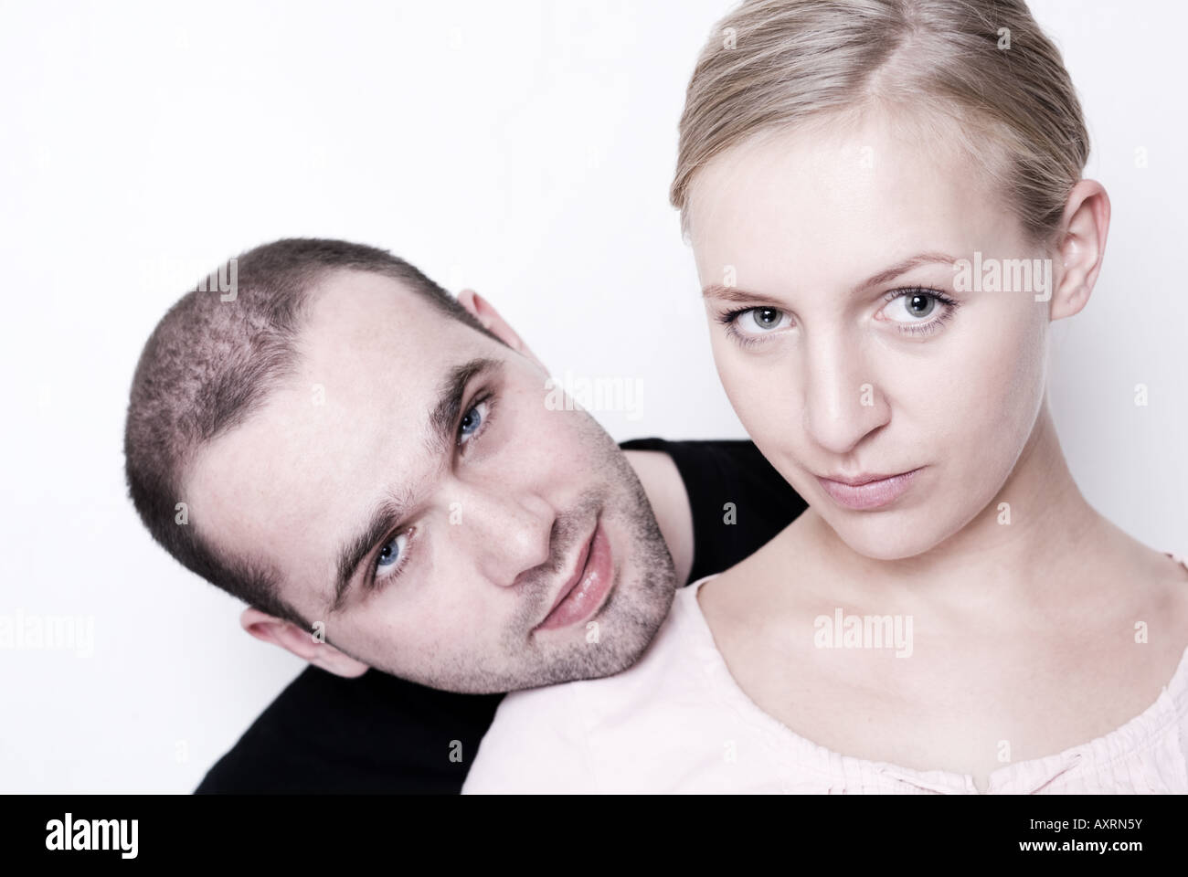 Couple looking at camera - focus on her eyes Stock Photo - Alamy