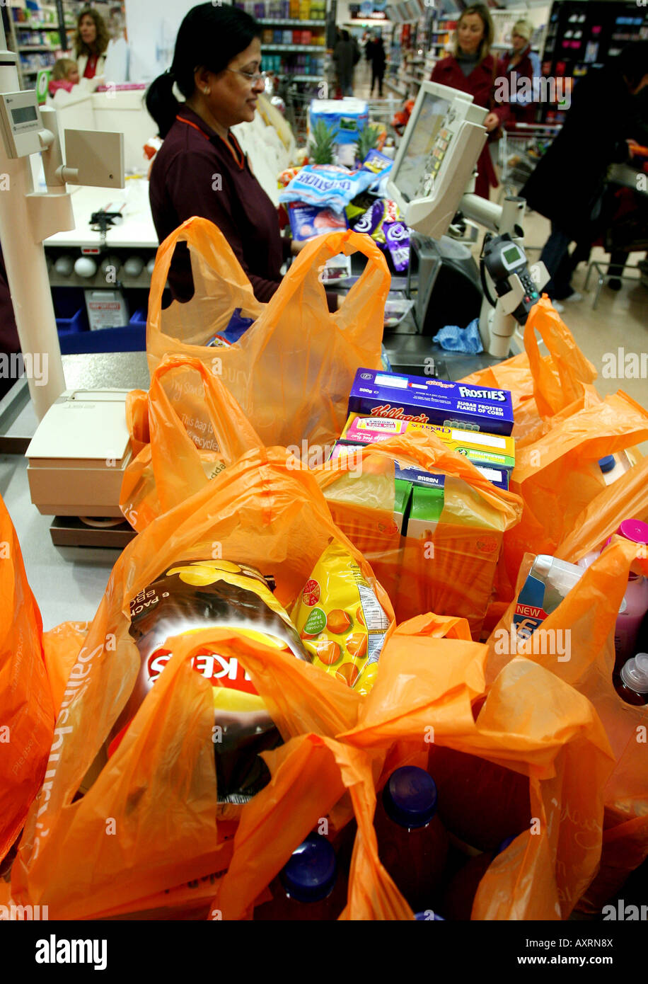 Shoppers pack their bags at the checkouts at Sainsbury s supermarket at ...