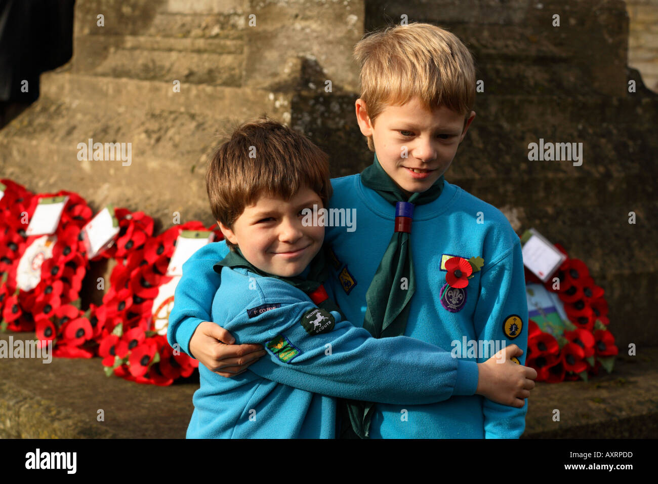 Two small boys in Beaver Cub Scout uniform hugging each other on ...