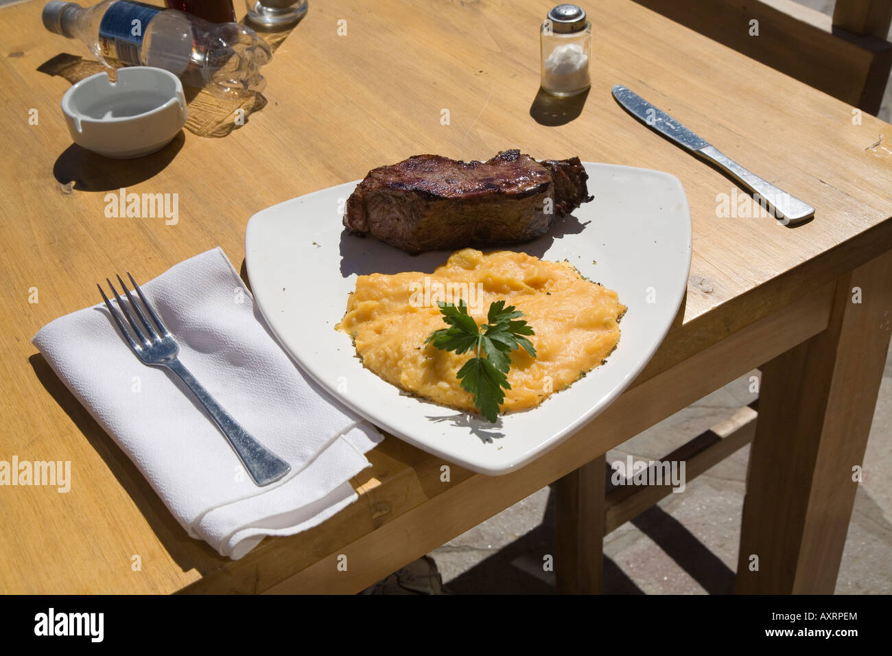 Steak on plate, half portion, ready to eat with knife and fork Stock ...