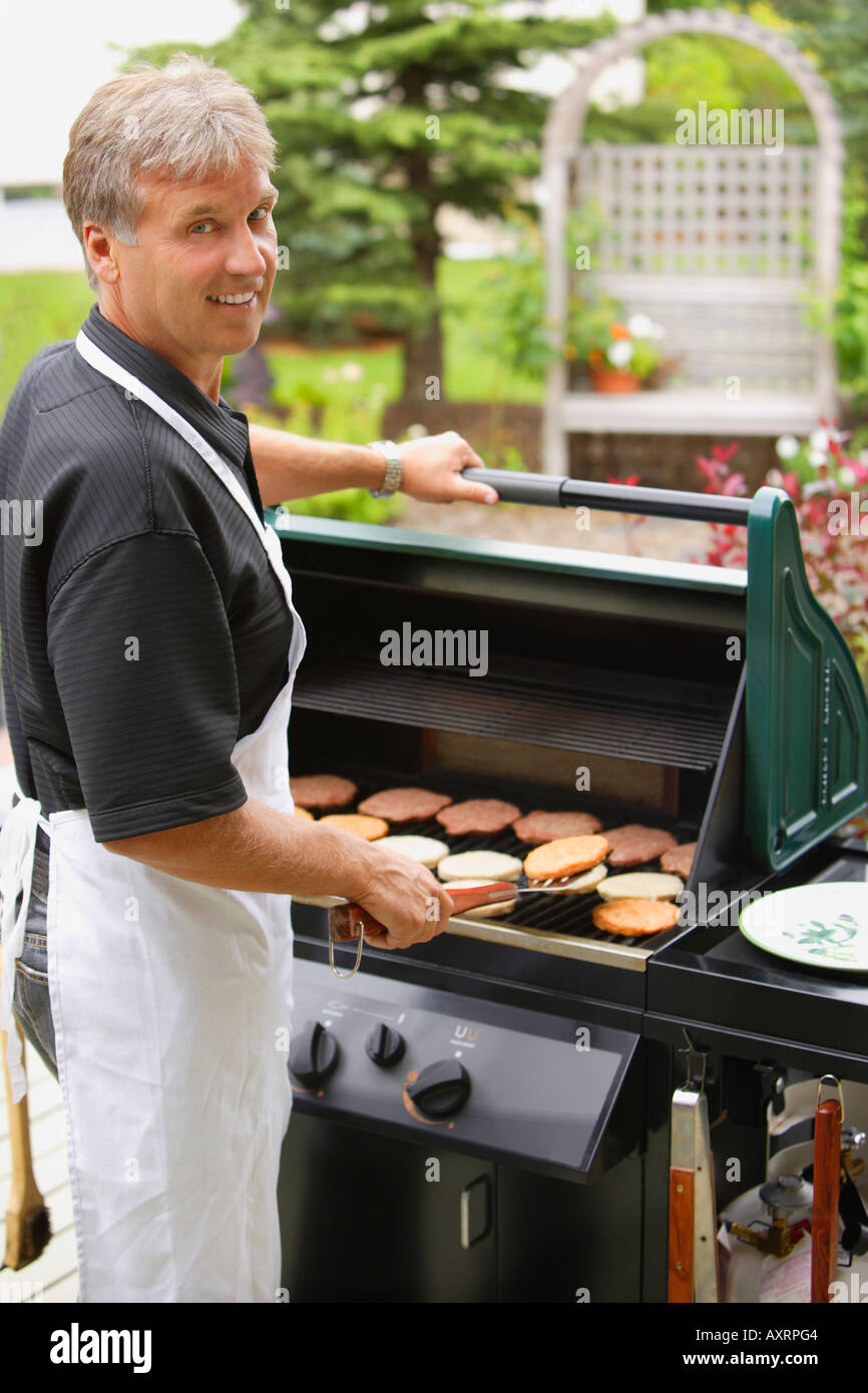 Man flipping burgers hi-res stock photography and images - Alamy