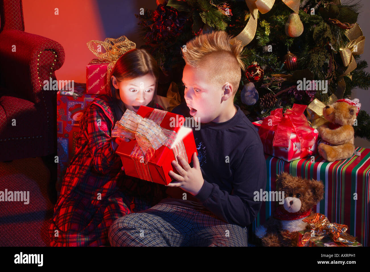 Children opening Christmas presents Stock Photo - Alamy
