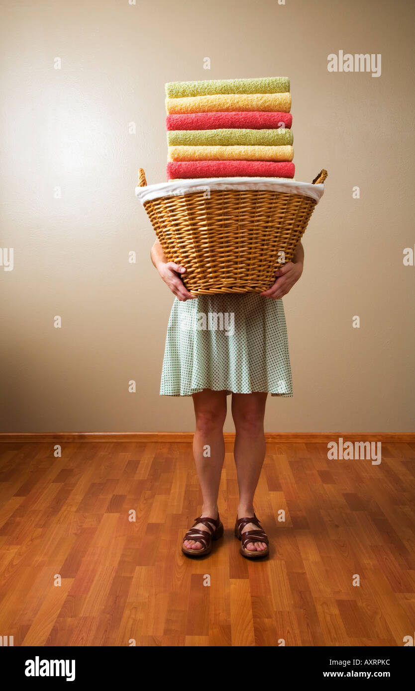 Woman carrying a laundry basket Stock Photo - Alamy
