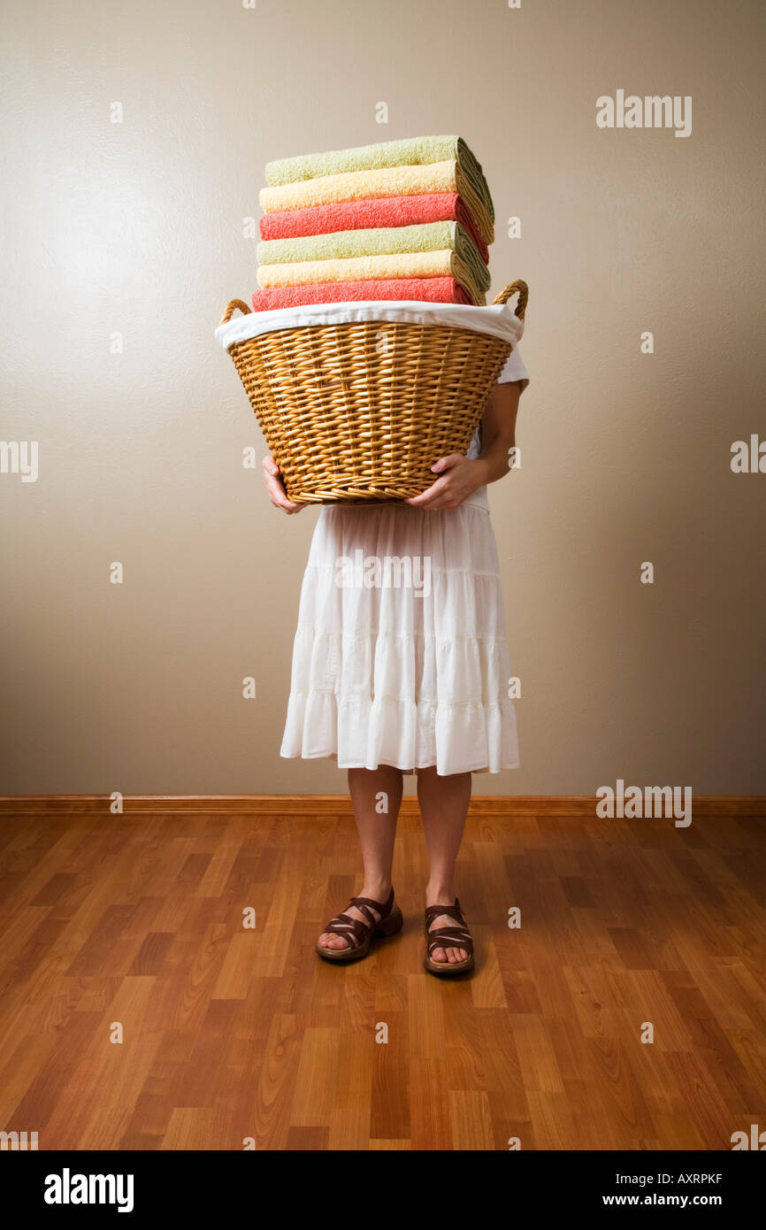 Woman carrying a laundry basket Stock Photo - Alamy