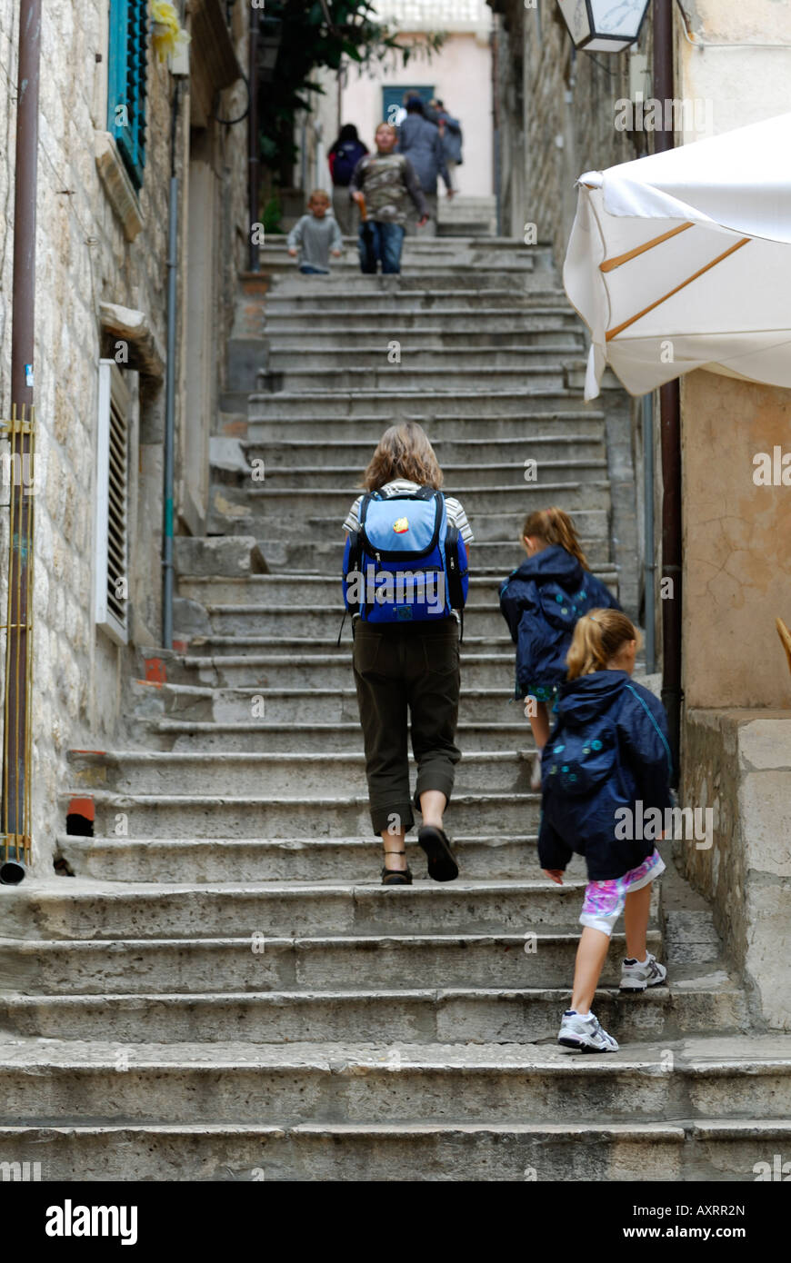 Woman and two children climbing steep steps, Dubrovnik old town ...