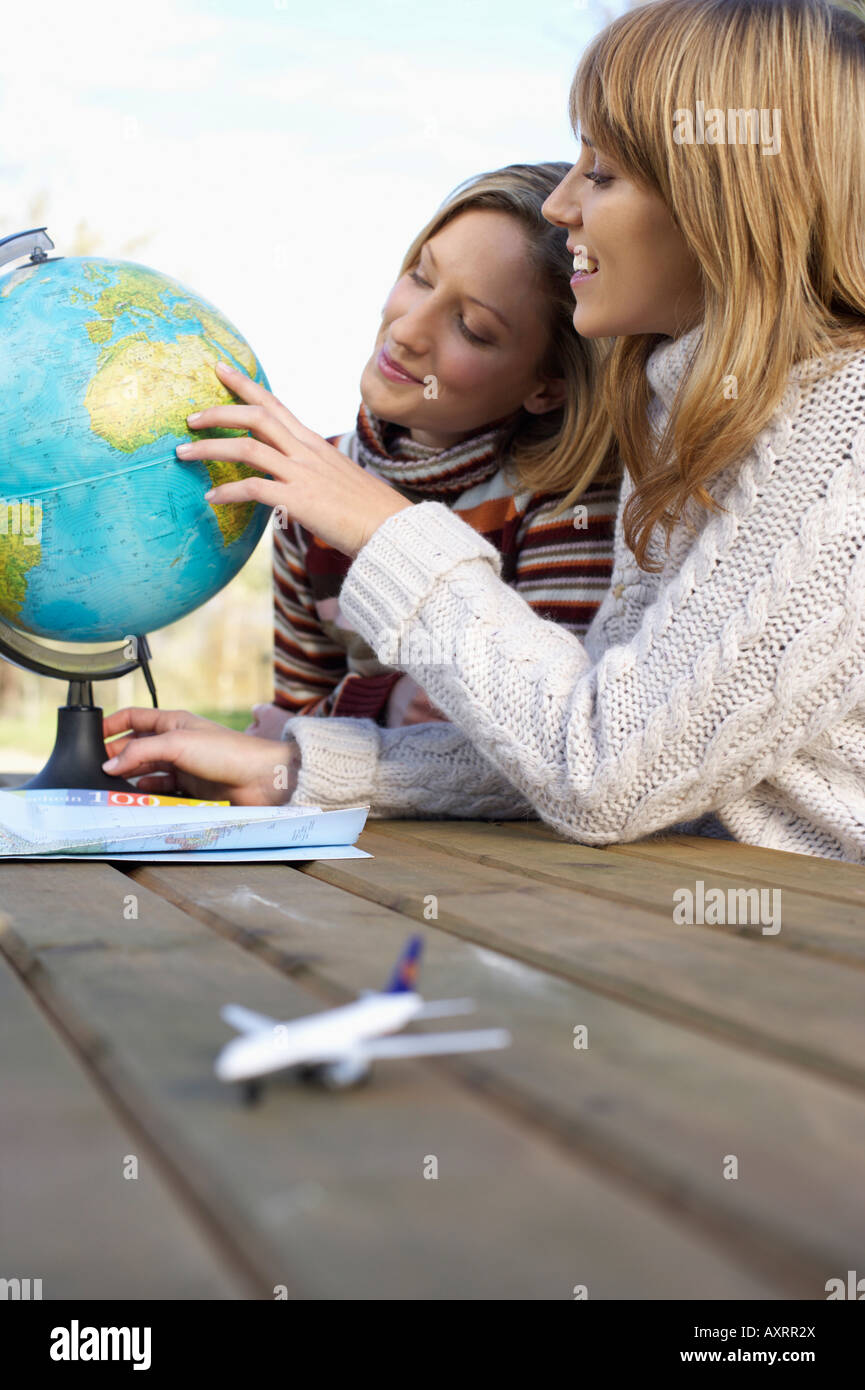 Two young women planning a journey, selective focus Stock Photo - Alamy