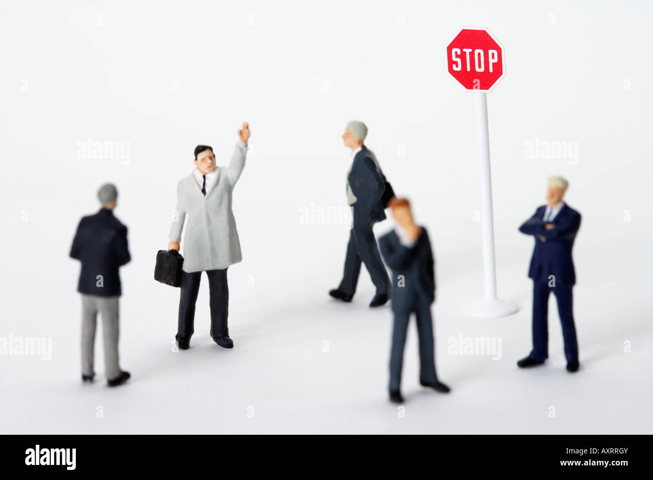 Businessmen figurines and a stop sign Stock Photo - Alamy