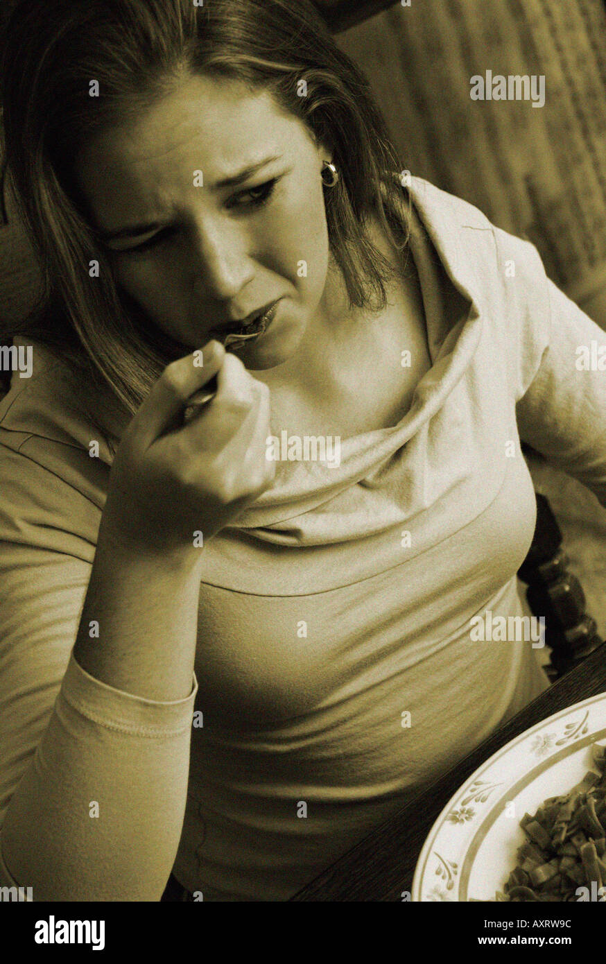 Reluctant Caucasian Teen Girl 15 to 17 Eats Bitter Food USA Stock Photo ...