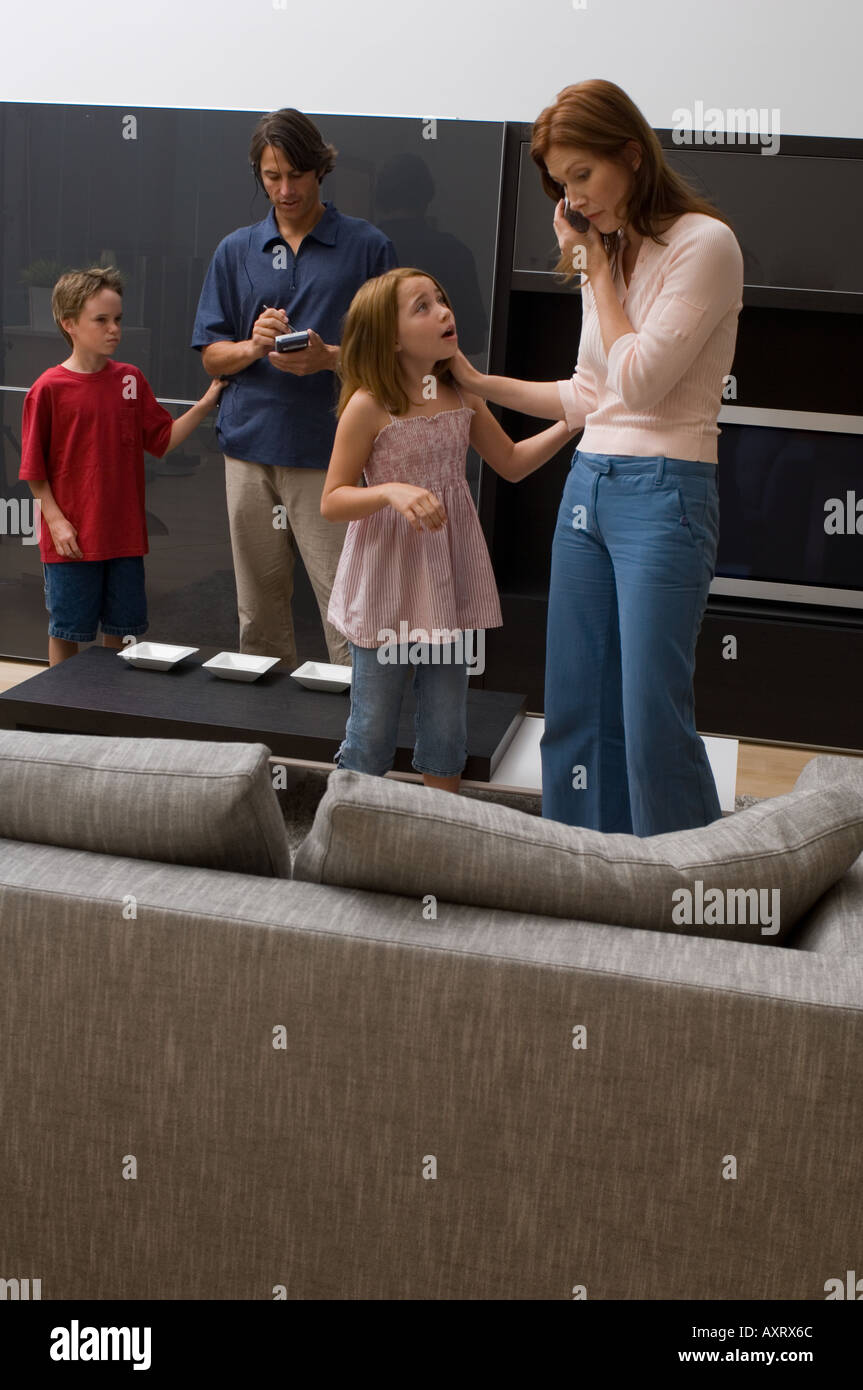 Portrait of two kids bothering their parents who are busy Stock Photo ...