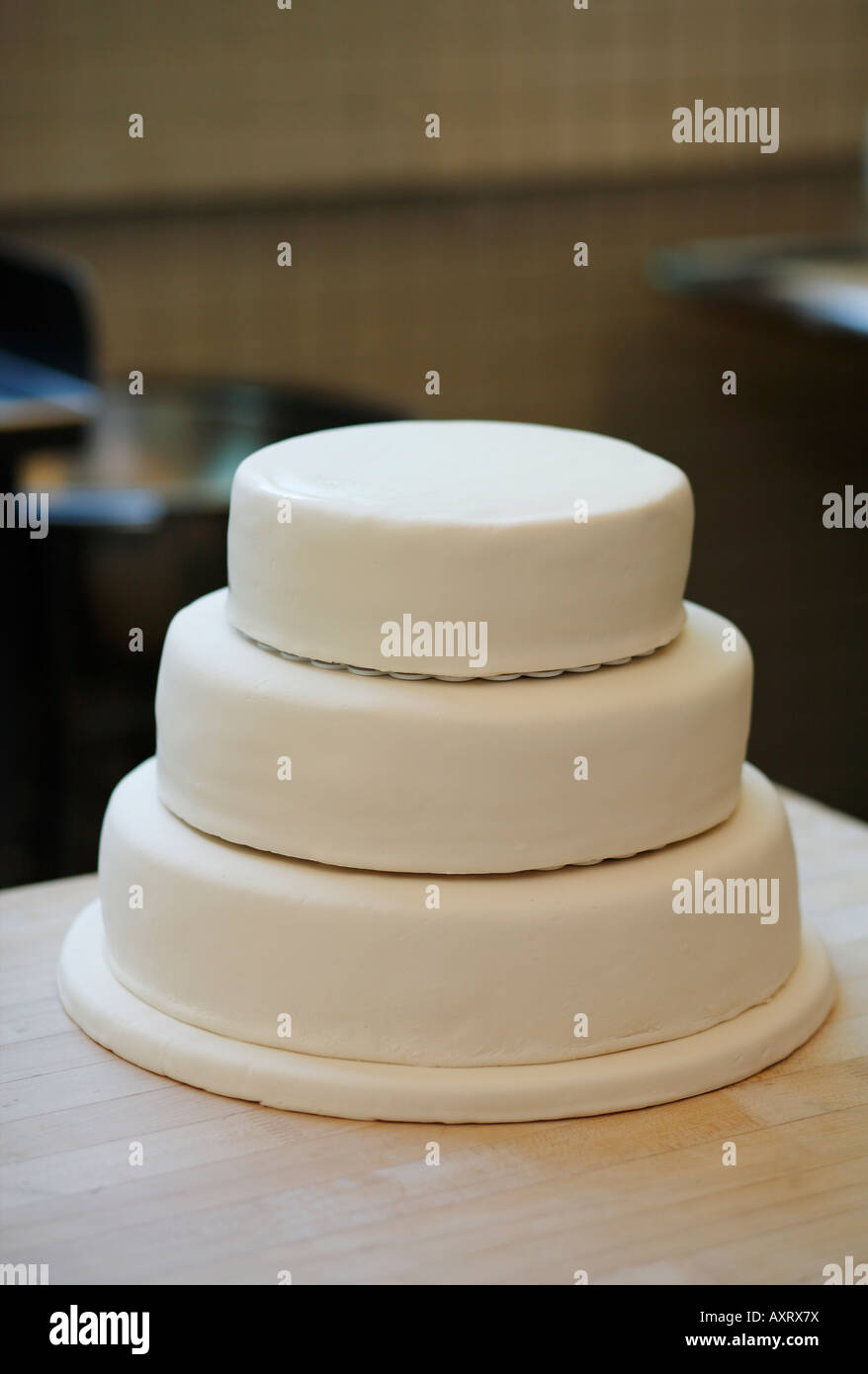 Unfinished three layer white wedding cake at the pastry shop Stock ...