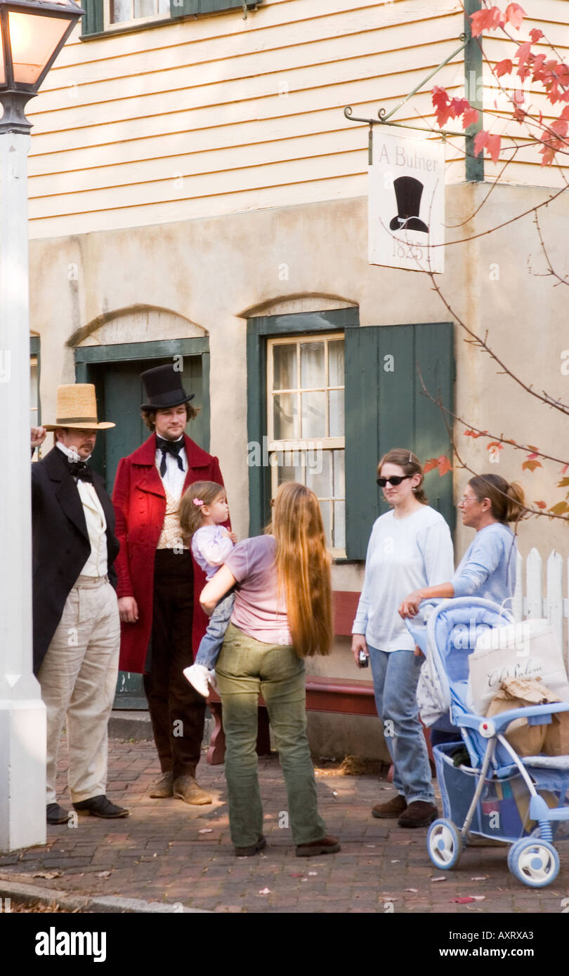 Two men dressed in authentic colonial attire engage in historical ...