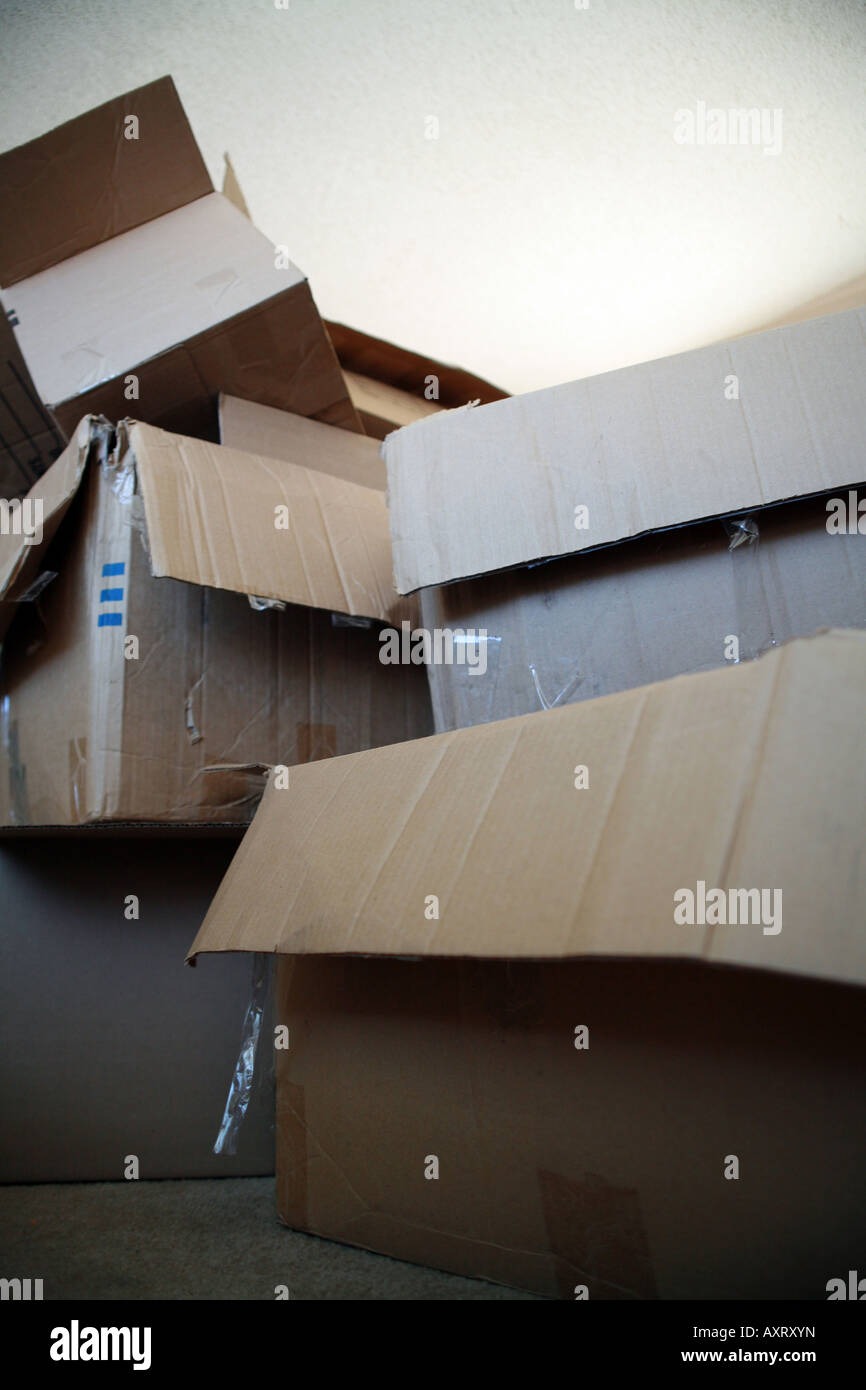 A Big Stack of Empty Moving Boxes piled in a New Home Stock Photo - Alamy