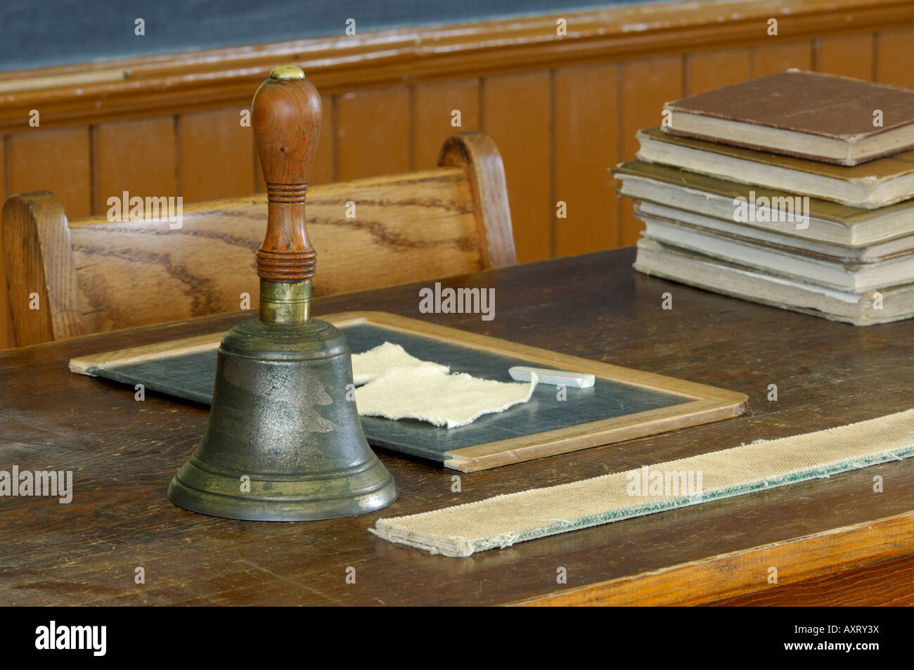 1920 s school teacher s desk with books slate chalk bell and strap ...