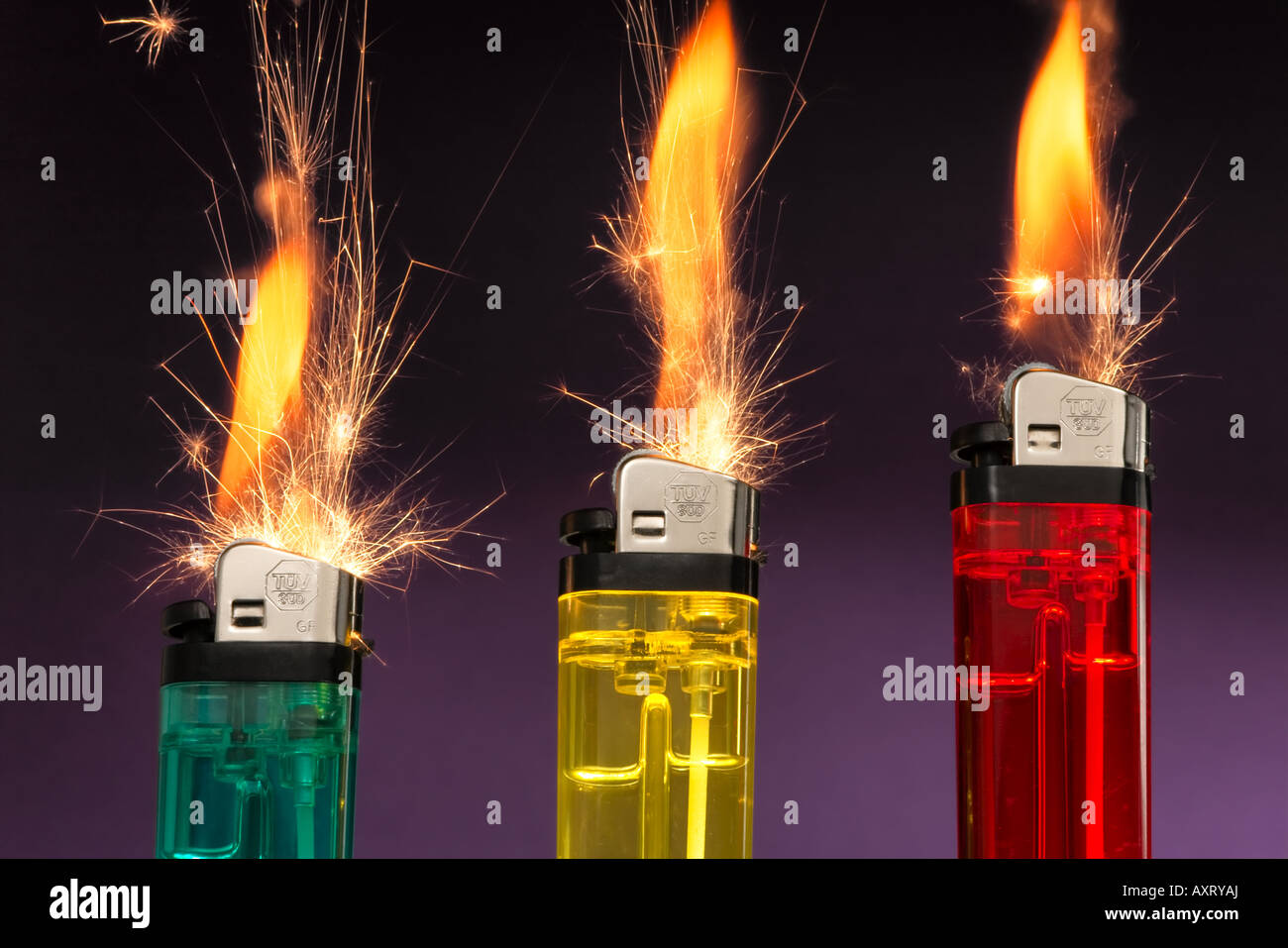 Three lighters shooting flames and sparks Stock Photo - Alamy