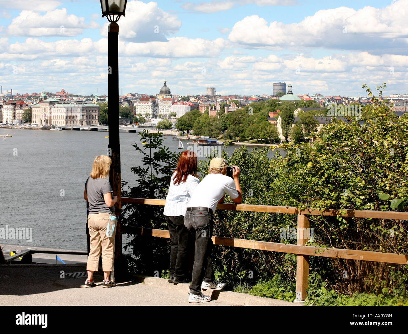 Three people gazing into the sea Stock Photo - Alamy