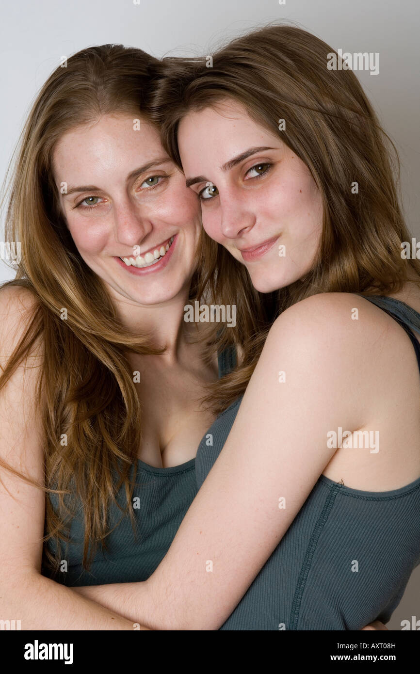 Sisters age 27 left and 20 right pose together in a studio portrait ...