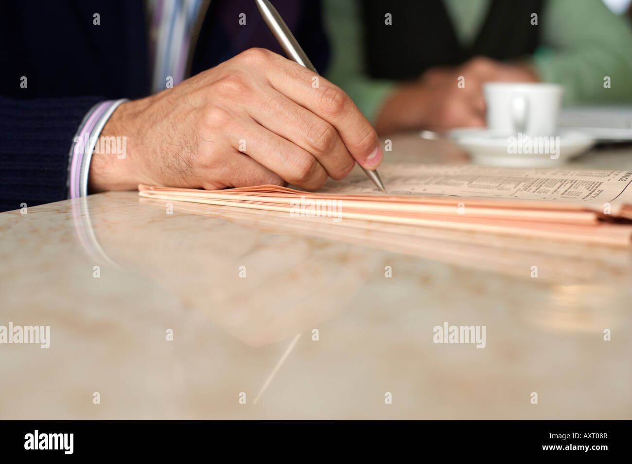 Businessman marking something in a newspaper Stock Photo - Alamy